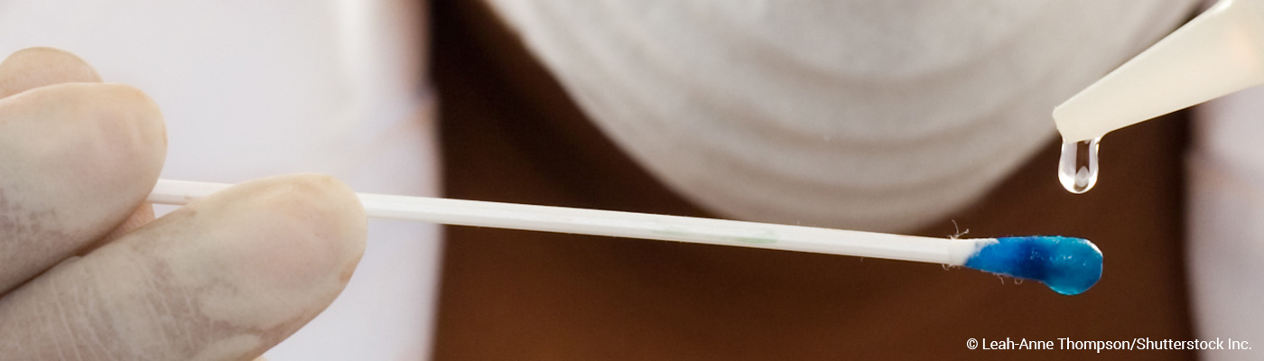 Forensic scientist drips solution onto swab hero background | National ...