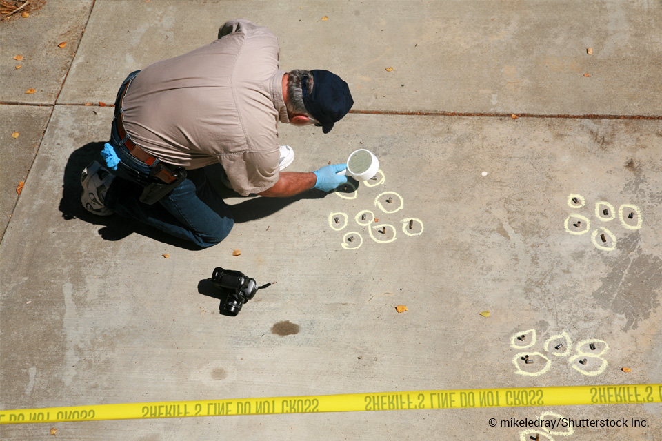 officer inspecting shell casings at a crime scene card | National ...